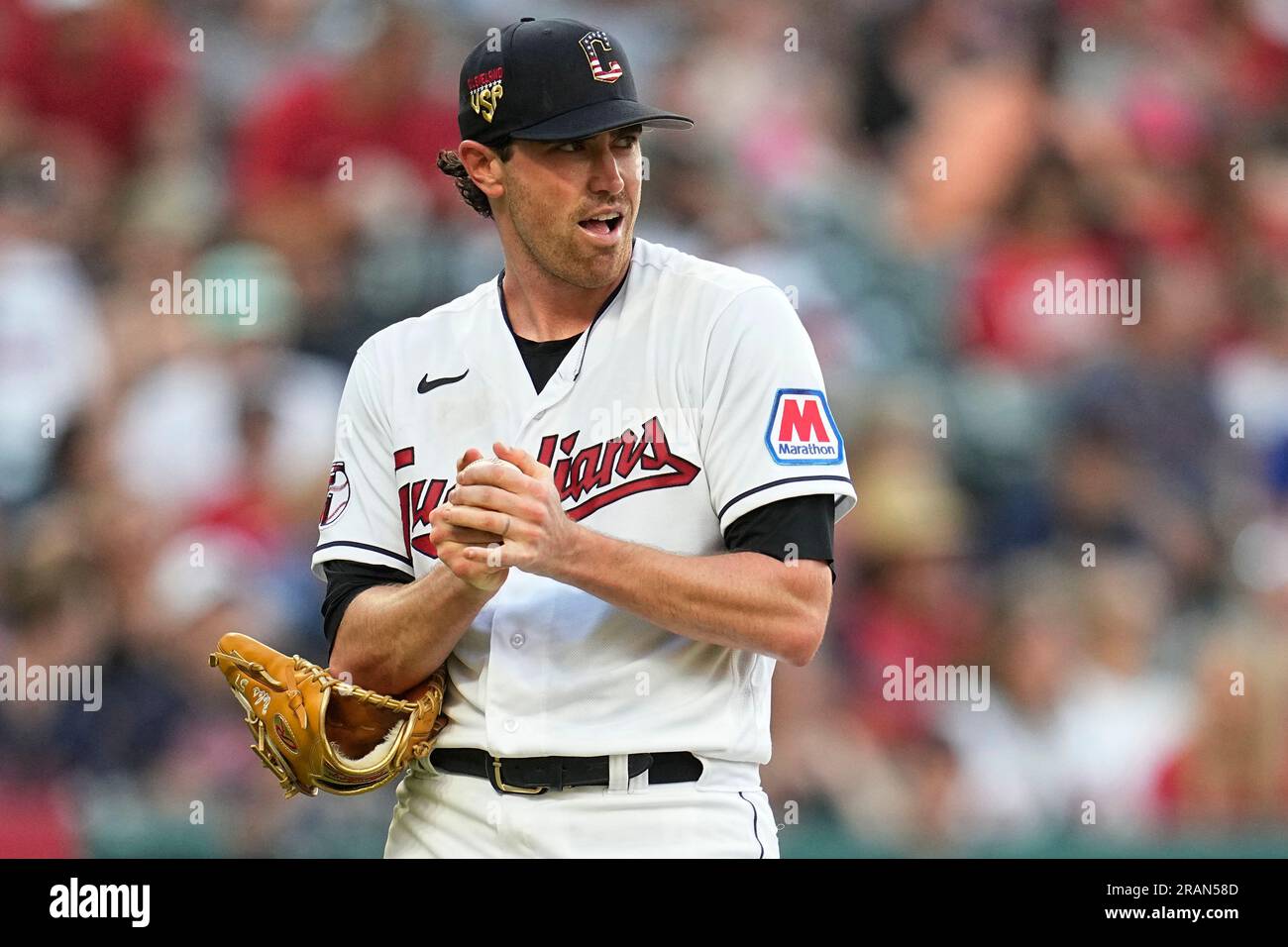 Cleveland Guardians starting pitcher Shane Bieber rubs up a new ball ...