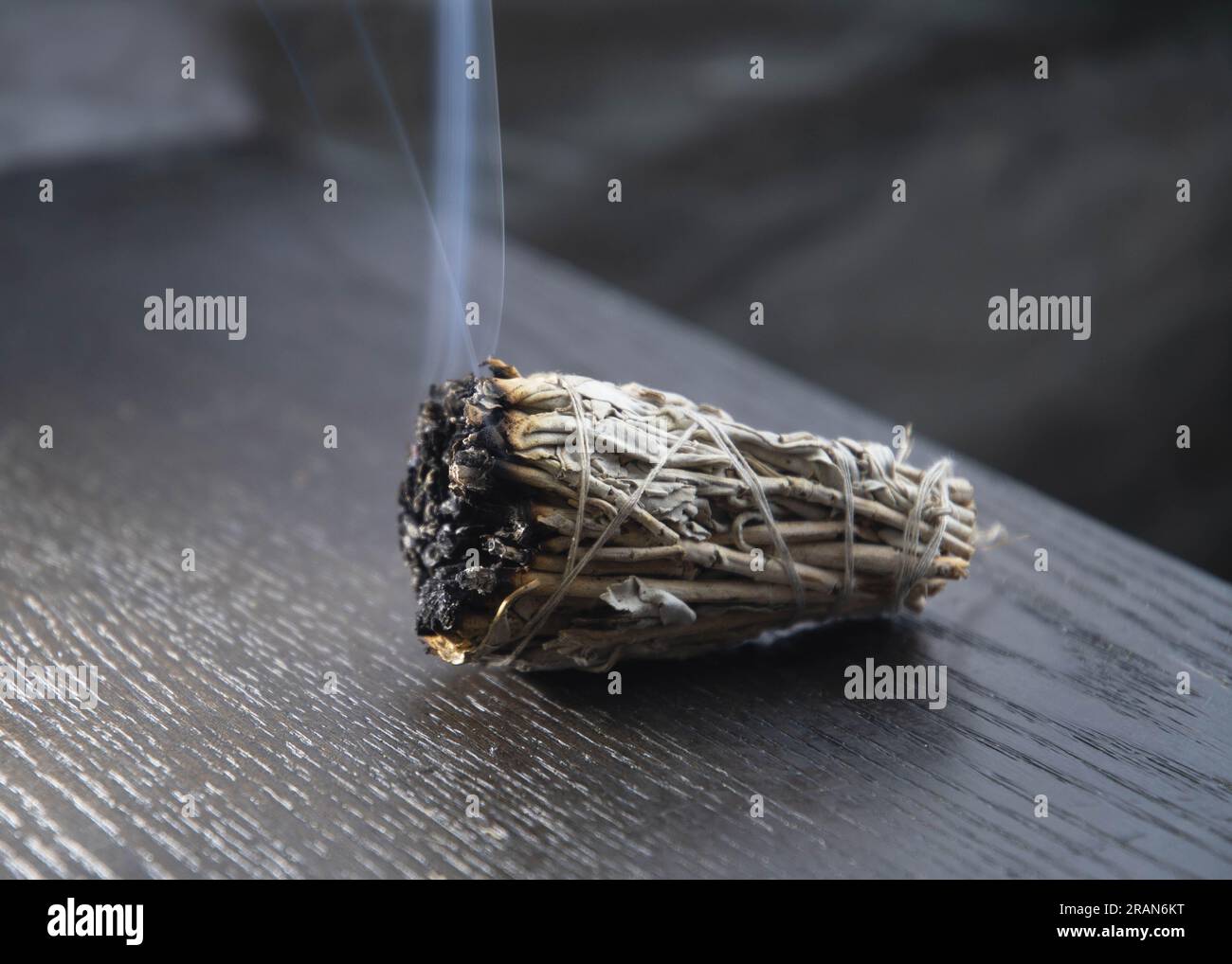 selective focus burning sage next to window natural light on black ...