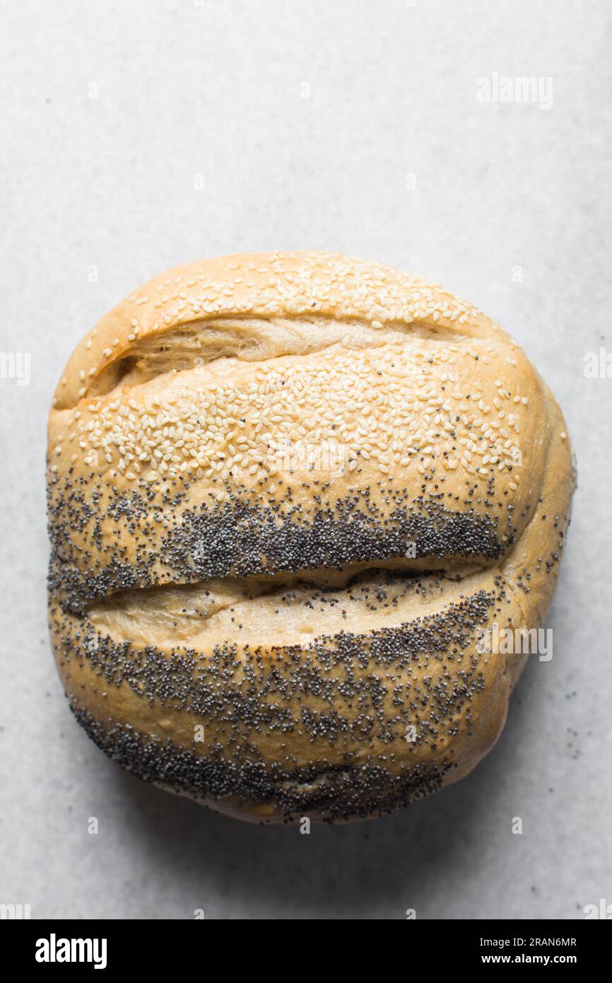 Top view of round homemade bread on a marble tray, Potbrood coated with ...