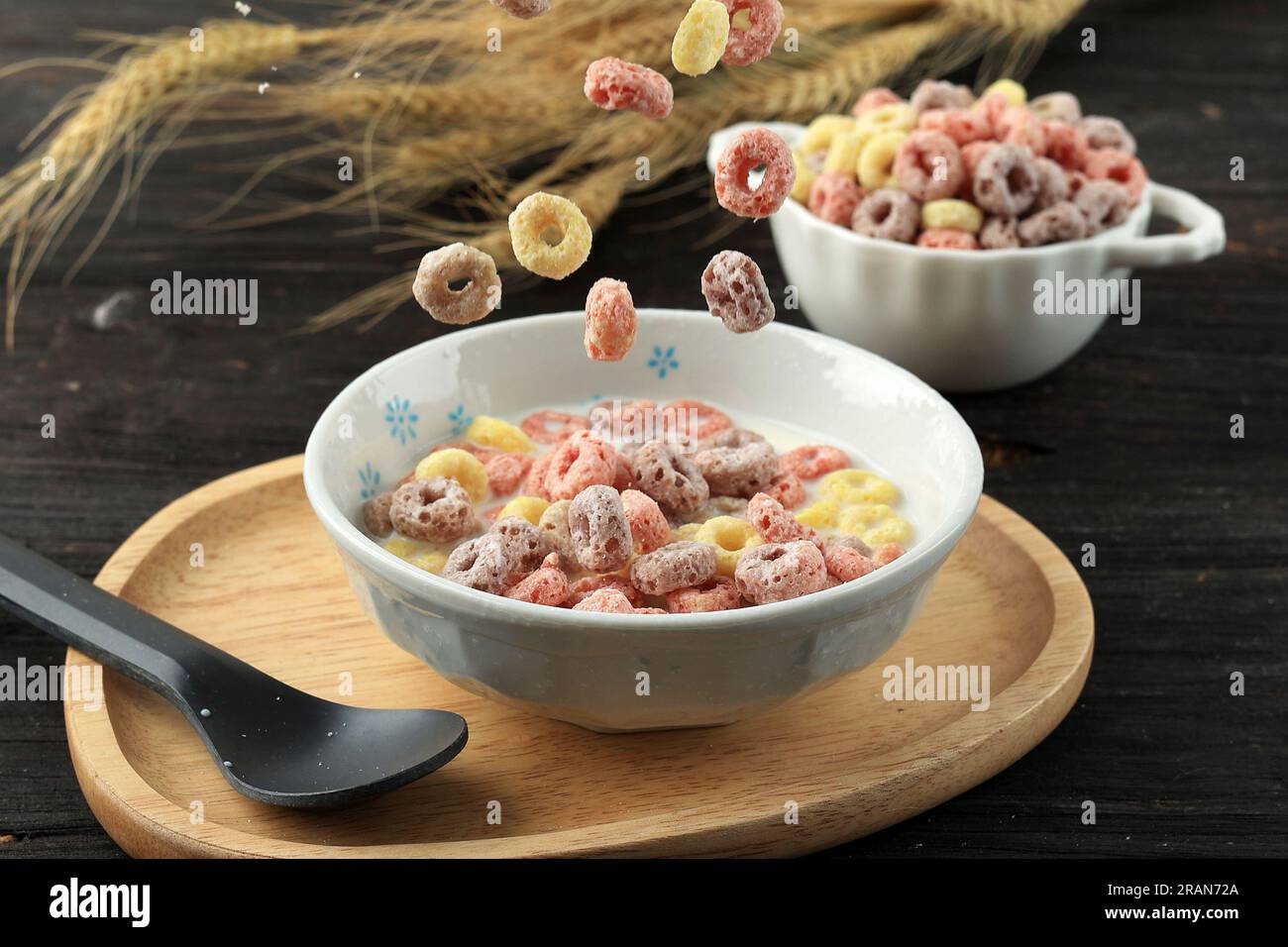 Pour Colored Fruit Grain Loops on A Bowl of Milk, Above Wooden Table ...