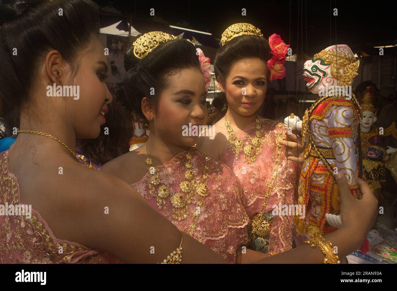 An unidentified of beautiful girls watching the Hanuman monkey puppet ...