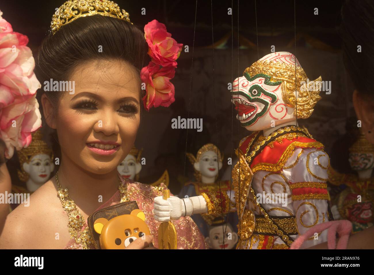 An unidentified of beautiful girls watching the Hanuman monkey puppet ...