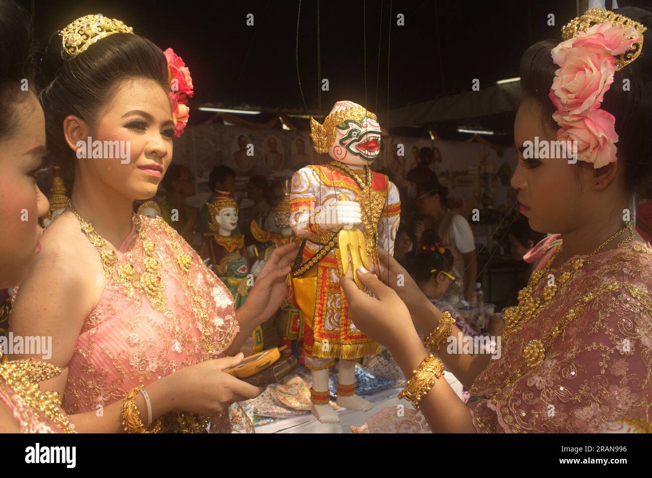 An unidentified of beautiful girls watching the Hanuman monkey puppet ...