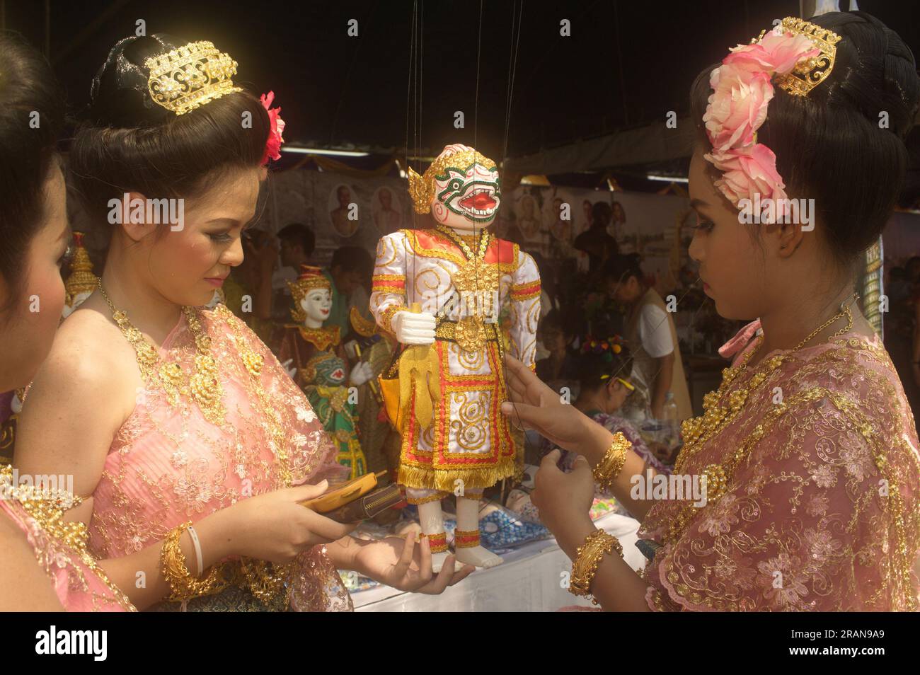 An unidentified of beautiful girls watching the Hanuman monkey puppet ...