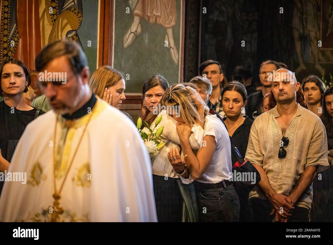 Two women hug each other during the memorial service of Ukrainian ...