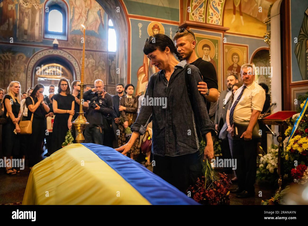 A woman mourns the death of Ukrainian writer Victoria Amelina, 37 ...
