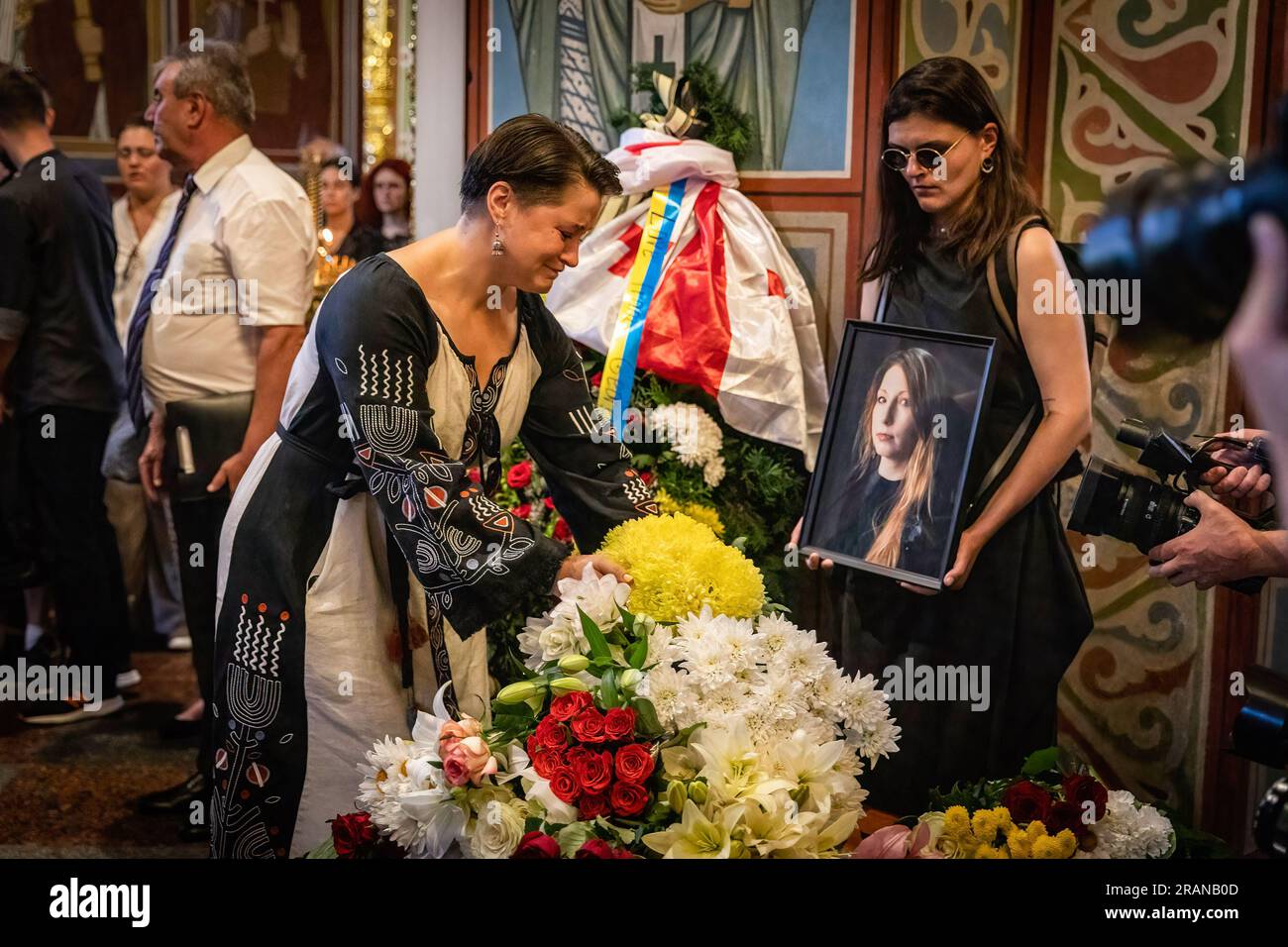 A woman puts down her flowers as she pays tribute to the fallen ...