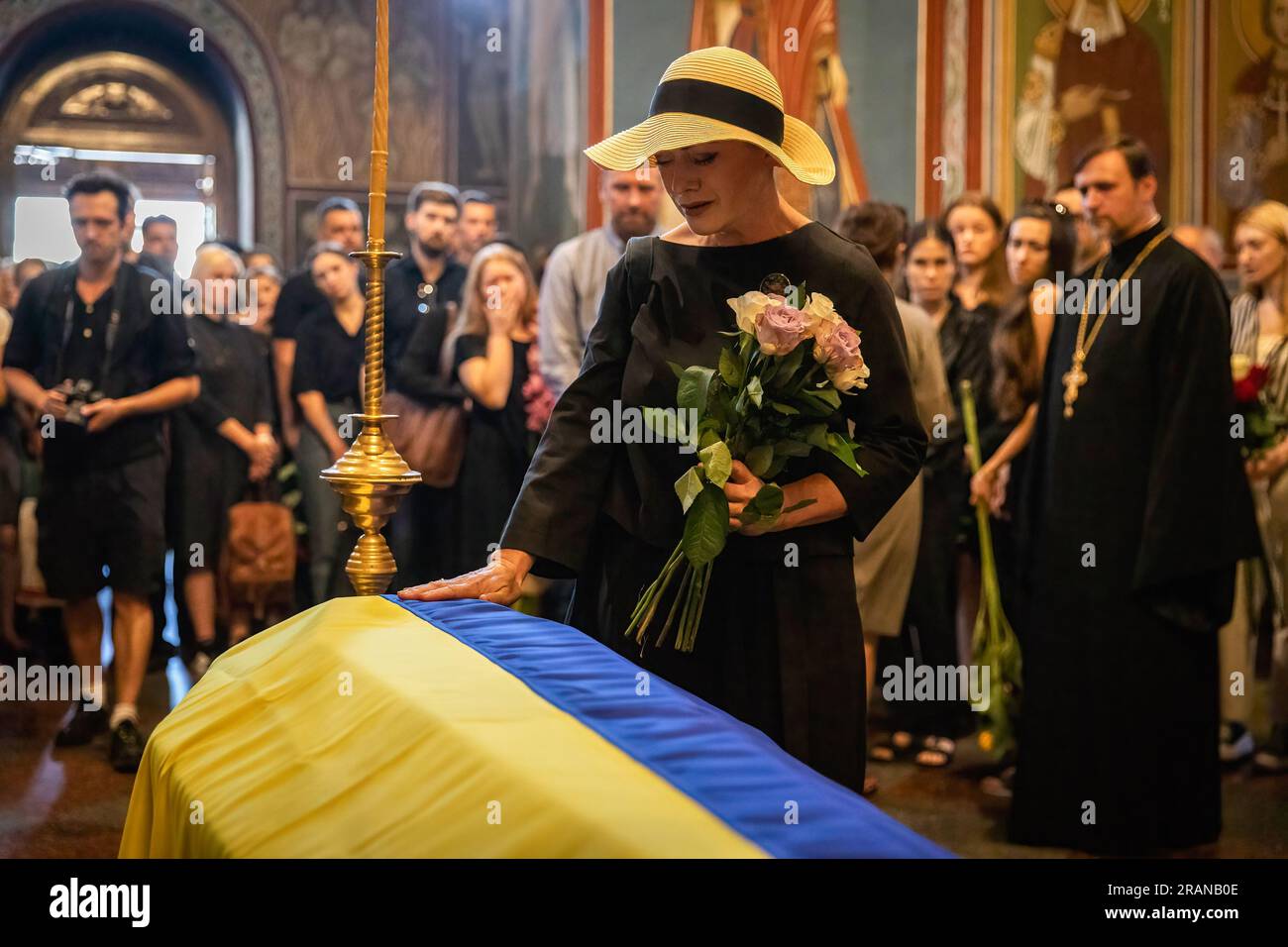 A woman holding flowers mourns the death of Ukrainian writer Victoria ...
