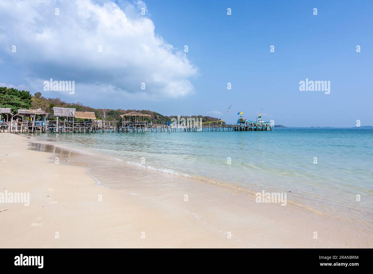 beautiful tropical beach with old wooden pier and huts Stock Photo - Alamy