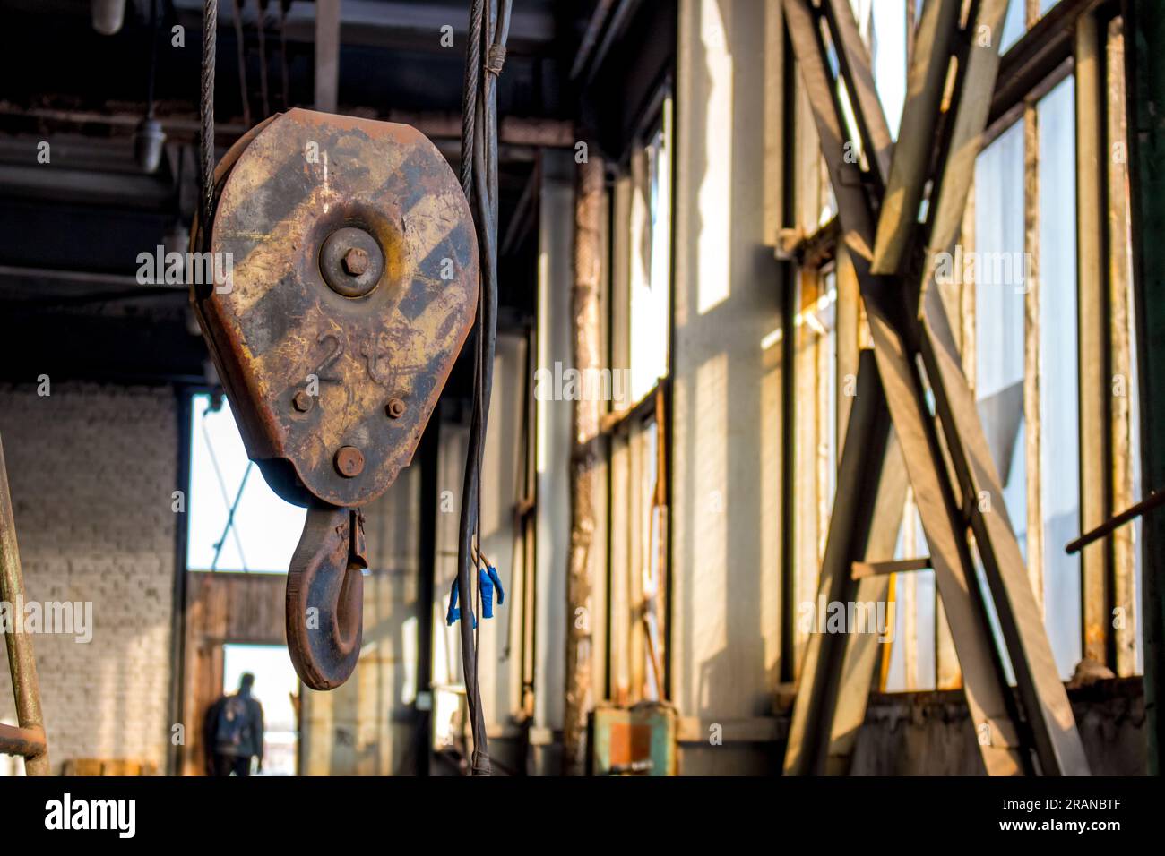 Metal lifting hook on the territory of an industrial building. Lifting ...