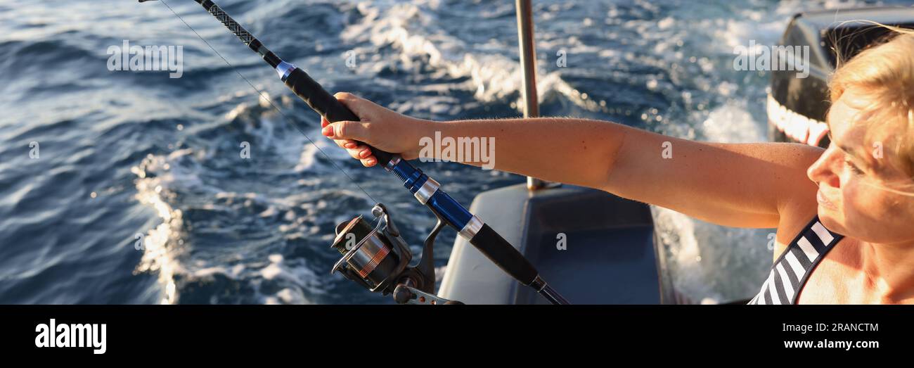 Hand woman holding fishing rod hi-res stock photography and images - Alamy