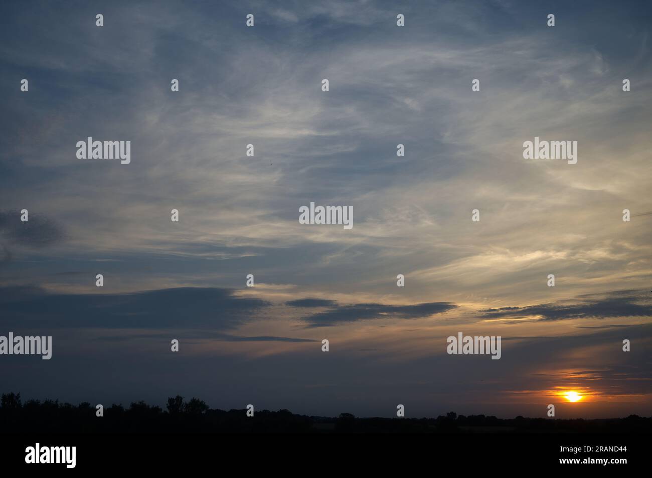 Sky with a beautiful blend of grey and dark clouds illuminated by a ...