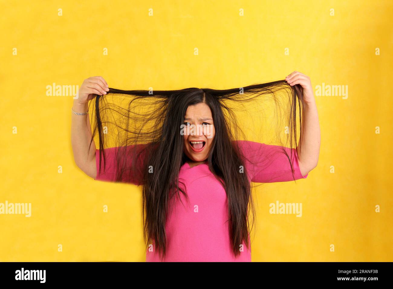 Adult 40-year-old Latina woman ruffles her hair desperate with anxiety ...