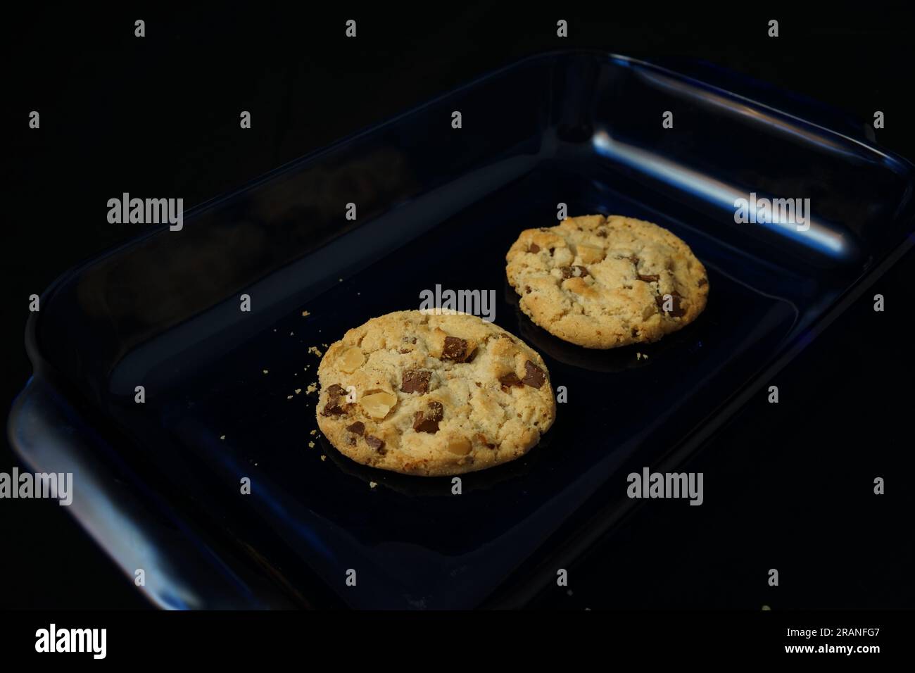 Closeup cookies in the blue glass tray with black background Stock ...