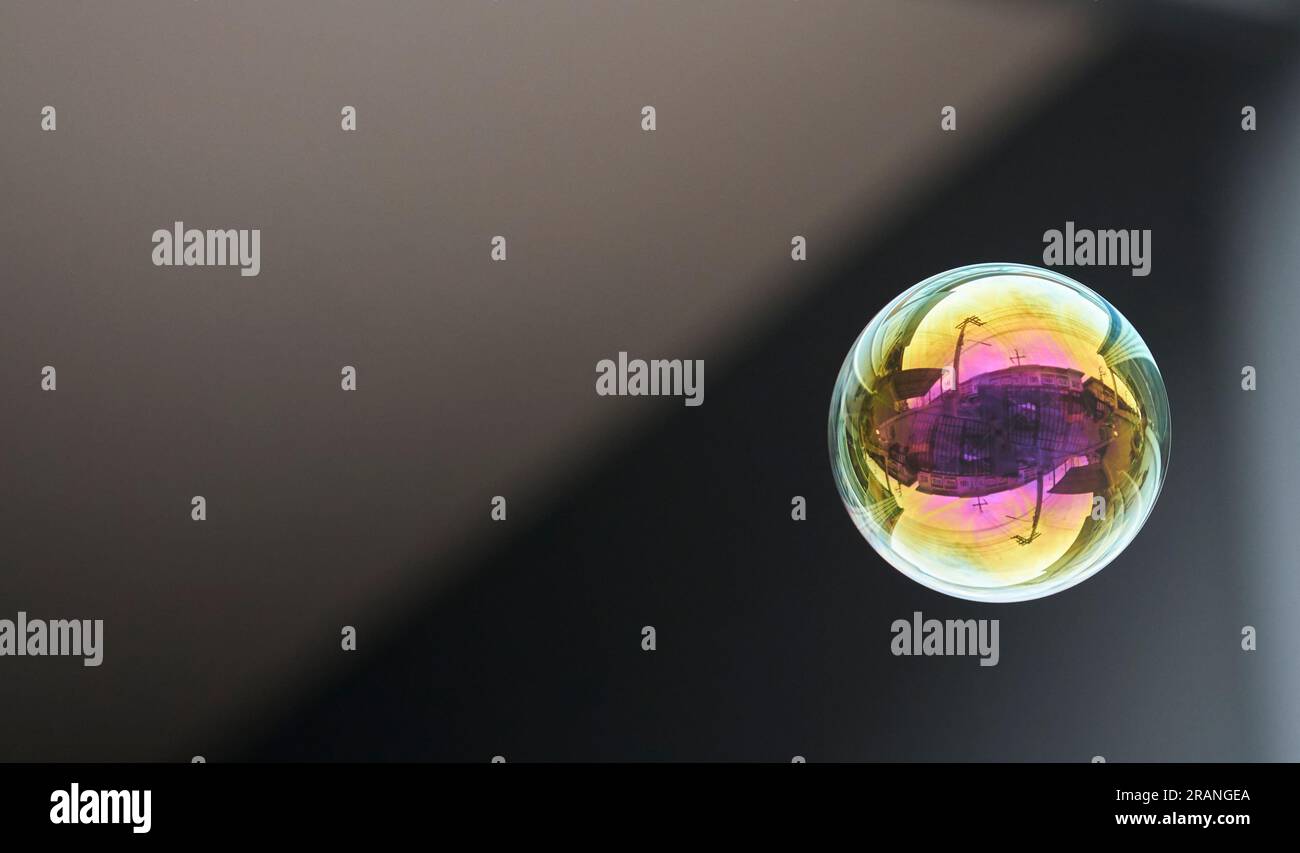A floating bubble with reflections of a house, conceptual image ...