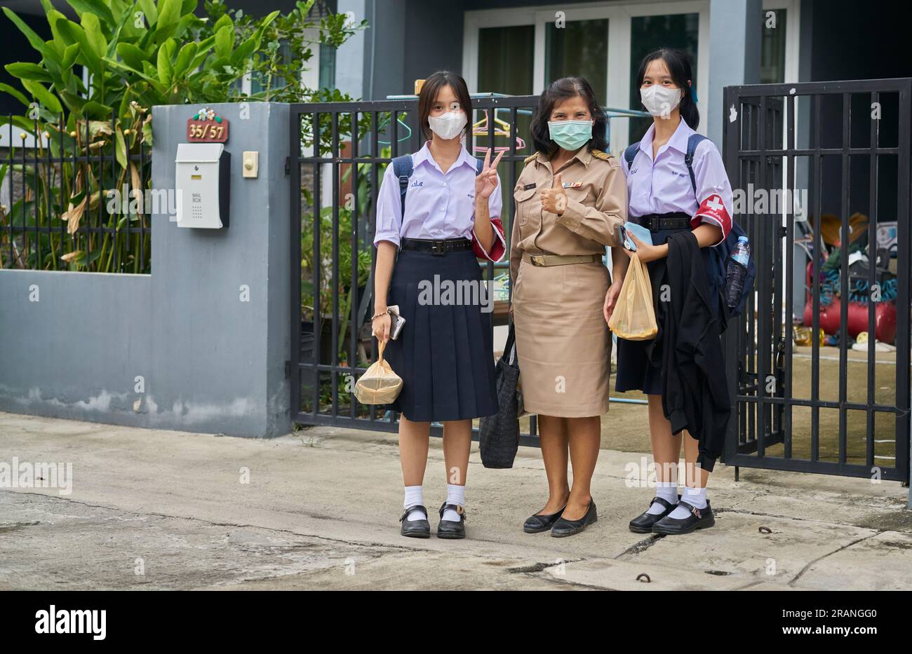 a Thai teacher and her daughters all dressed in their school uniforms Stock Photo - Alamy
