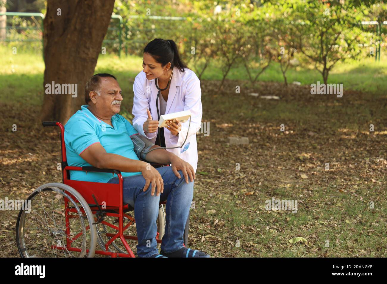 Using body monitoring device to checkup the old patient hi-res stock ...