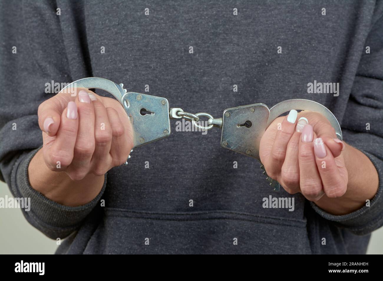women's hands are handcuffed in close-up Stock Photo - Alamy