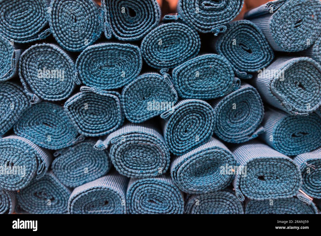 Blue fabrics rolls stack Stock Photo - Alamy