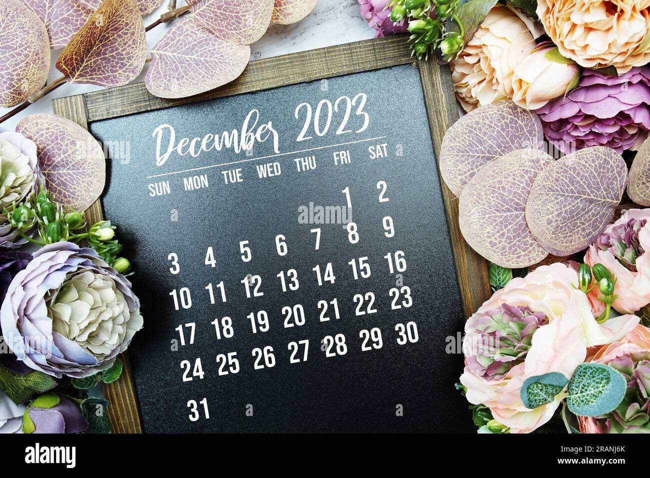 December 2023 monthly calendar with flower bouquet decoration on marble ...
