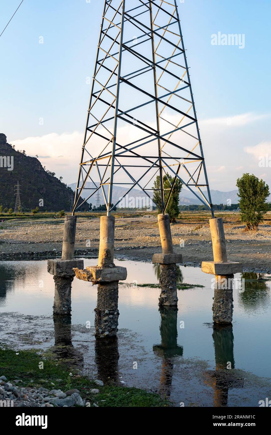 High voltage post in the river water after a heavy flood in the area ...