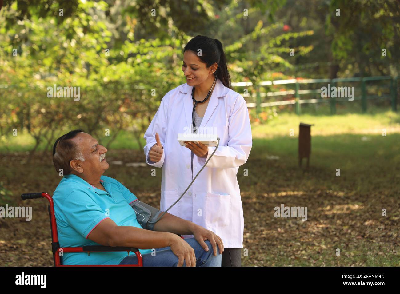Using body monitoring device to checkup the old patient hi-res stock ...