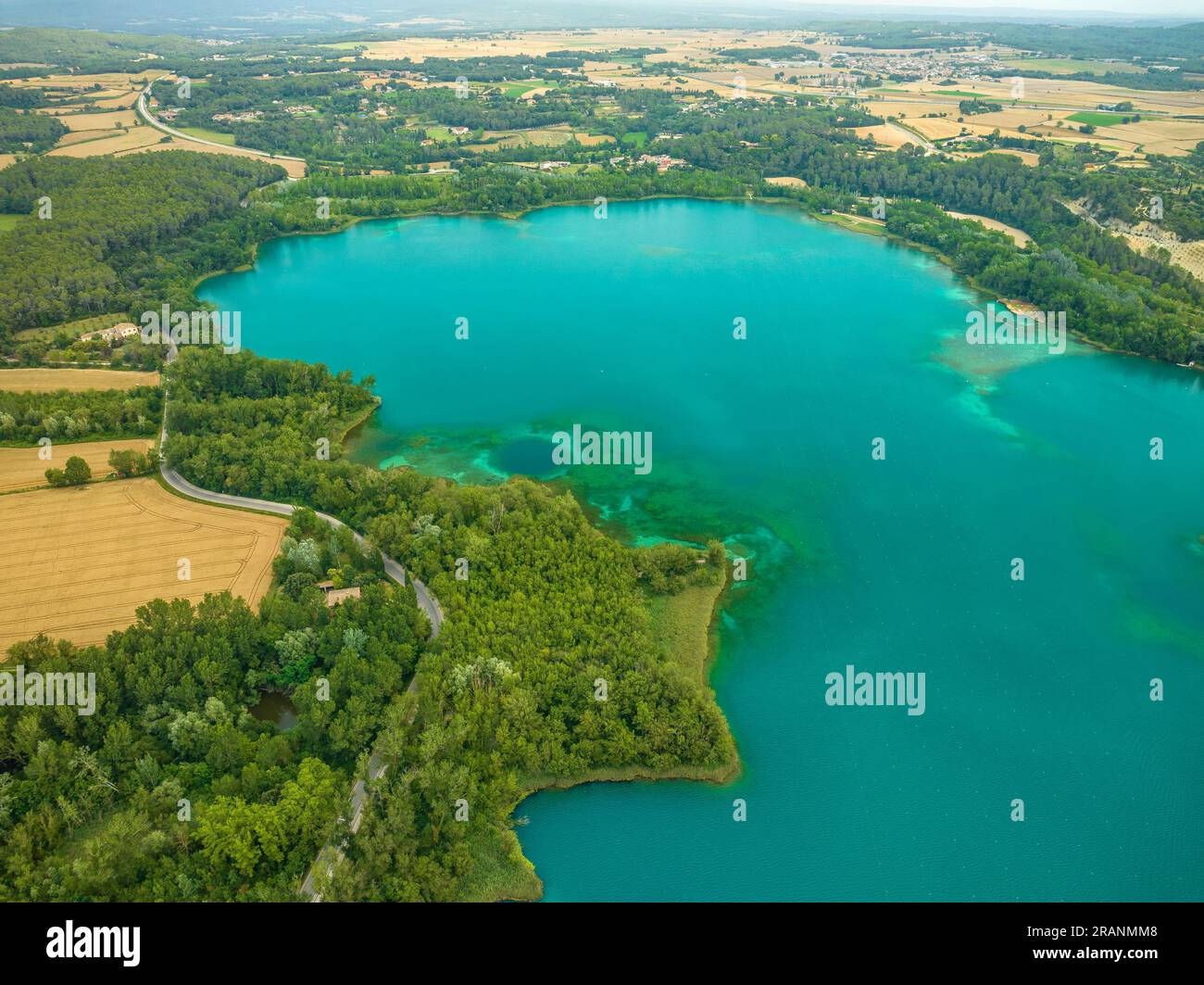 Aerial view of the Estany de Banyoles lake, the riverside forest and ...