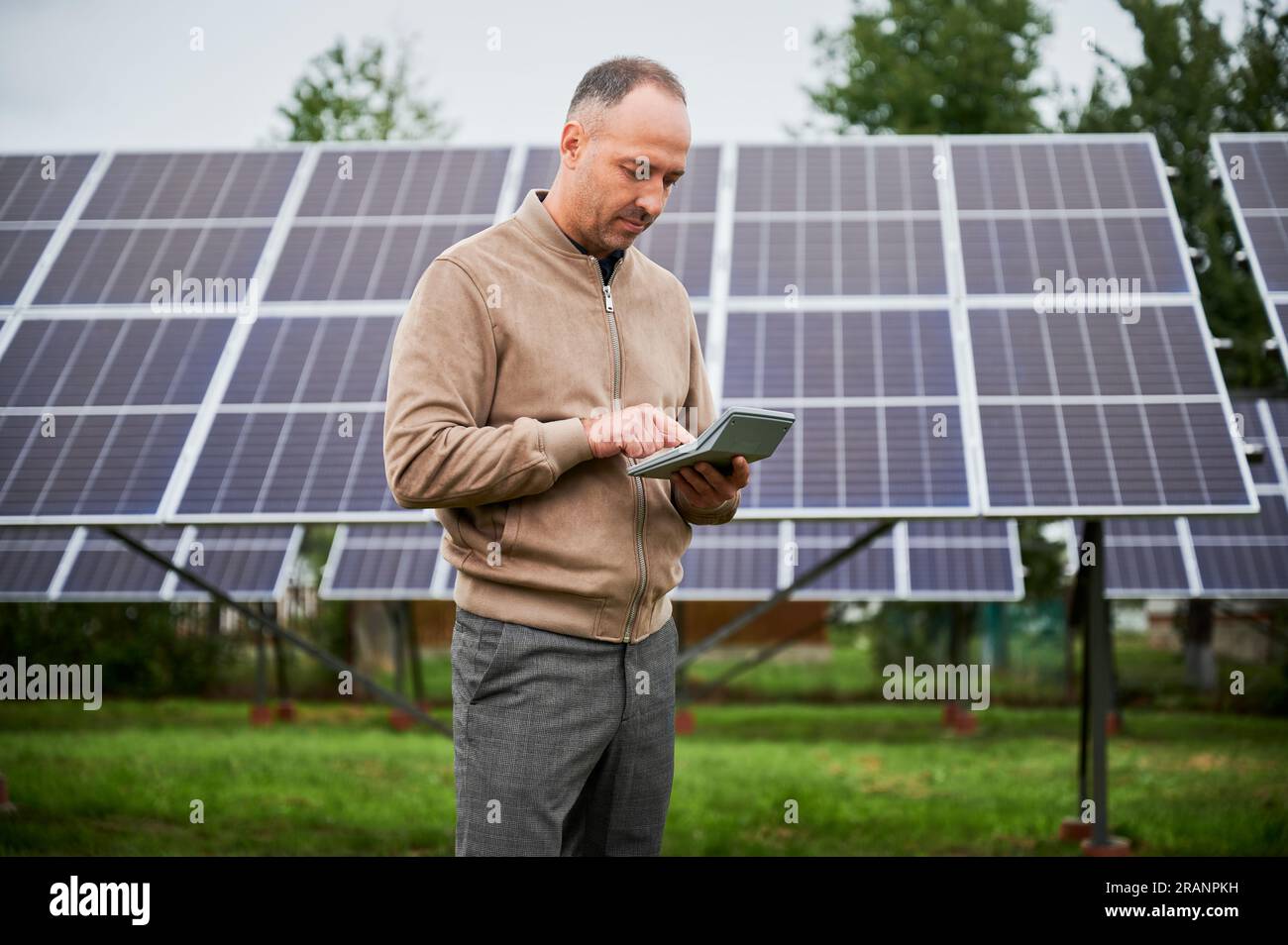 Male investor counting his future income from alternative energy ...