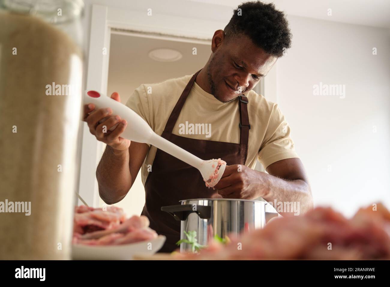 Young man using blender in hi-res stock photography and images - Alamy