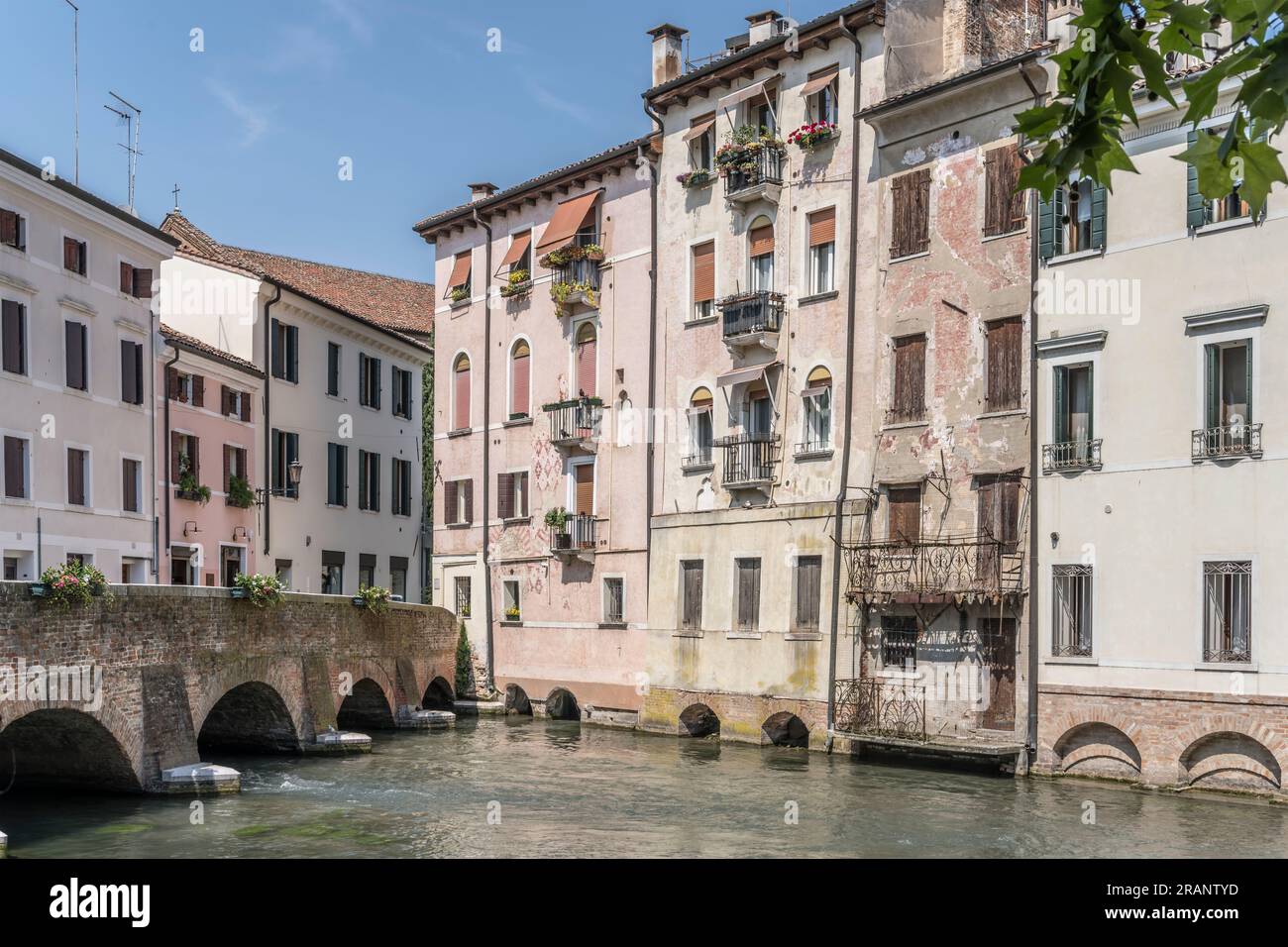 picturesque cityscape with old facades and masonry bridge on Cagnan ...