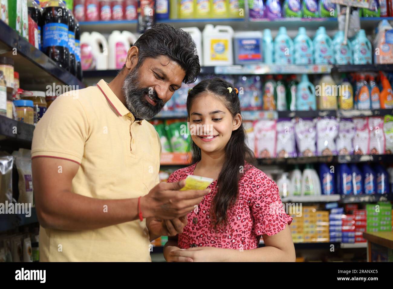Father with daughter purchasing in grocery store hi-res stock ...
