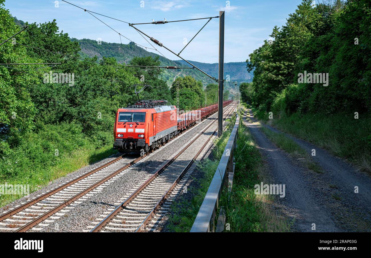 a train of the Deutsche Bundesbahn drives through the German green ...