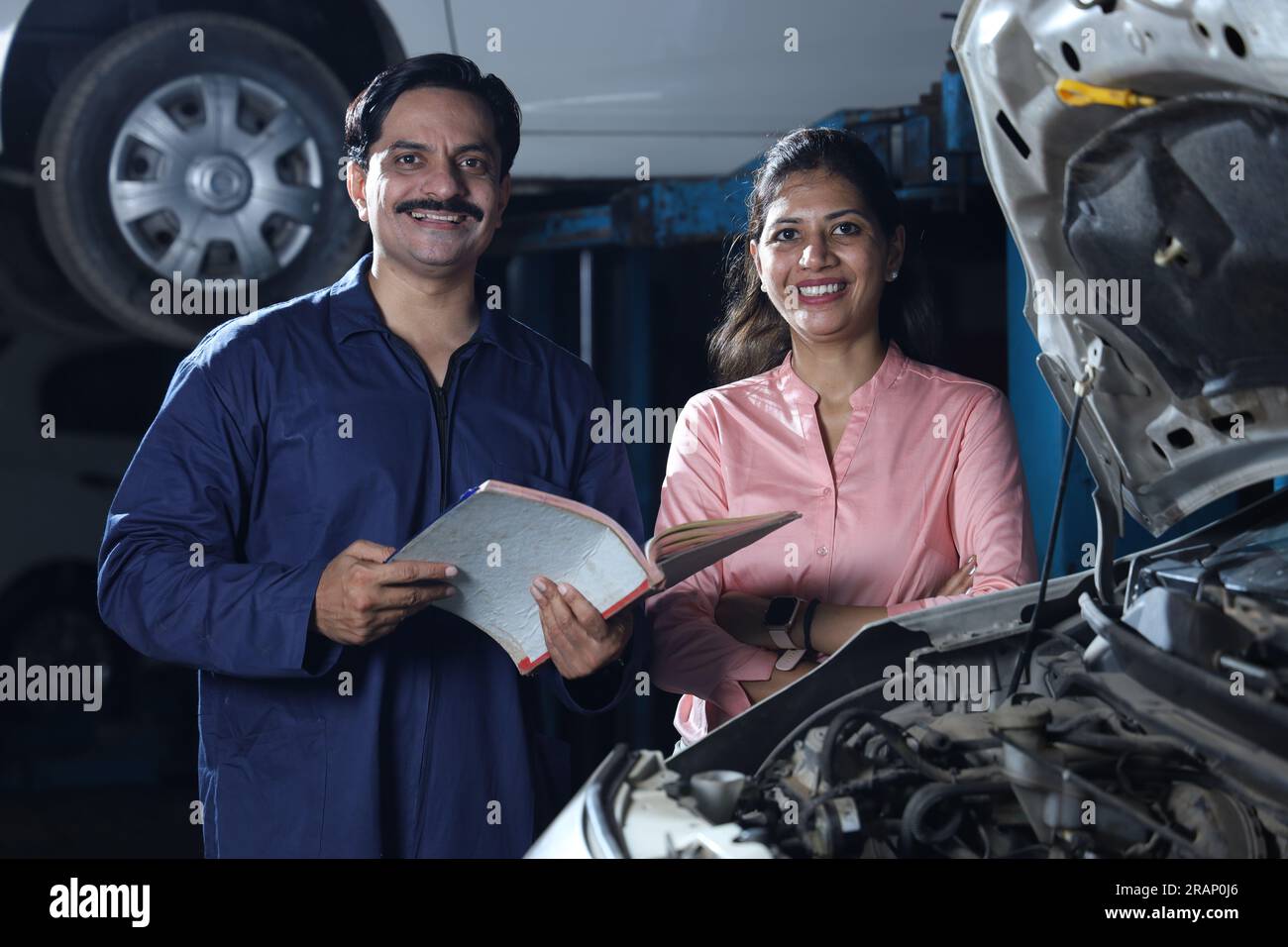 Happy female customer showing thumbs up for repairing her car on time ...
