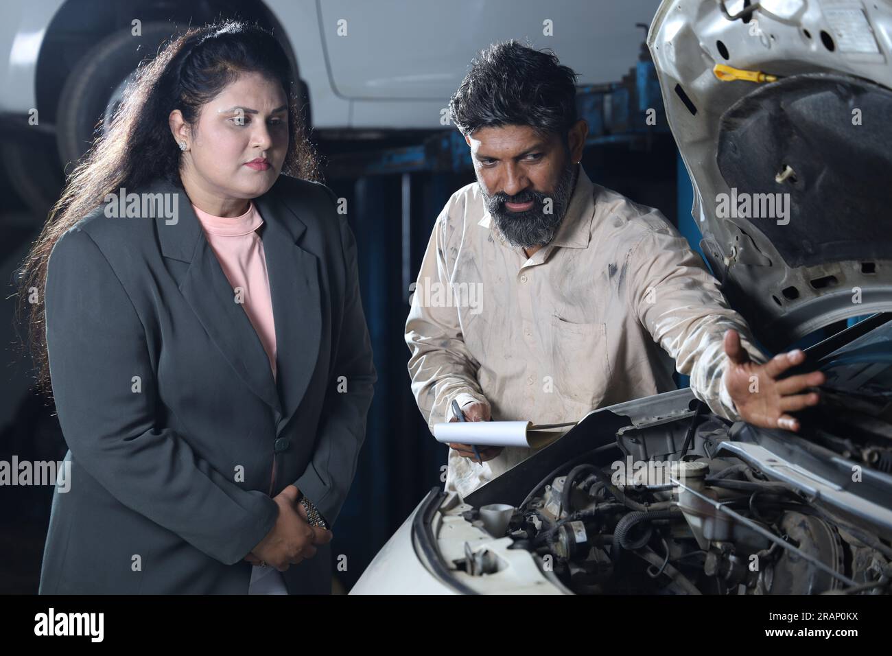 Happy customer shaking hands with mechanics hi-res stock photography ...