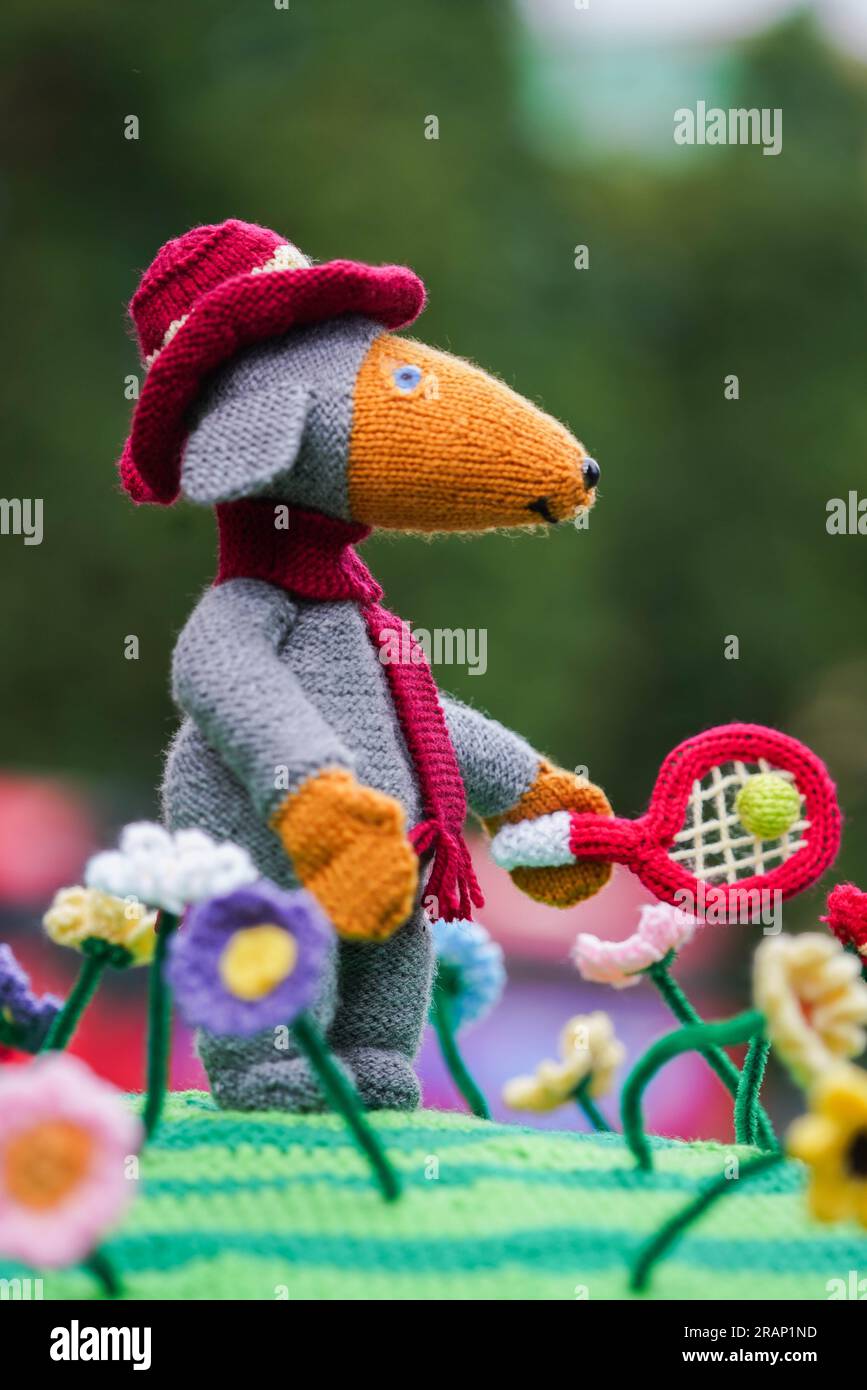 London UK. 5 July 2023 A knitted womble holding a tennis racket stands ...