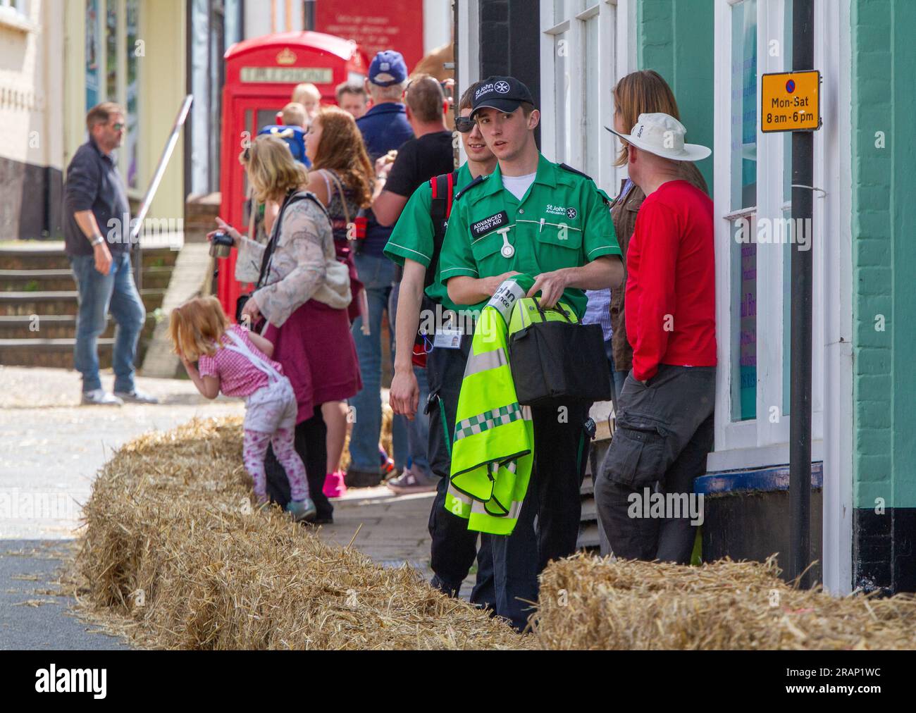 Two young St John Ambulance first aiders walk on the pavement at a ...