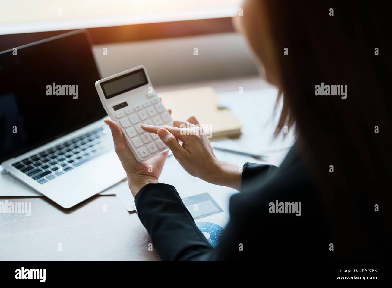 businesswoman or accountant working on calculator and laptop computer ...