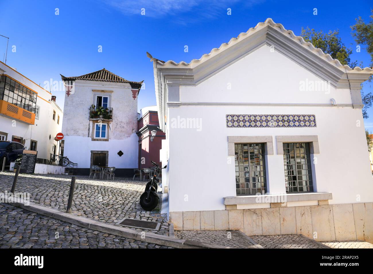Tavira, Portugal- October 20, 2022: Narrow cobblestone street and ...