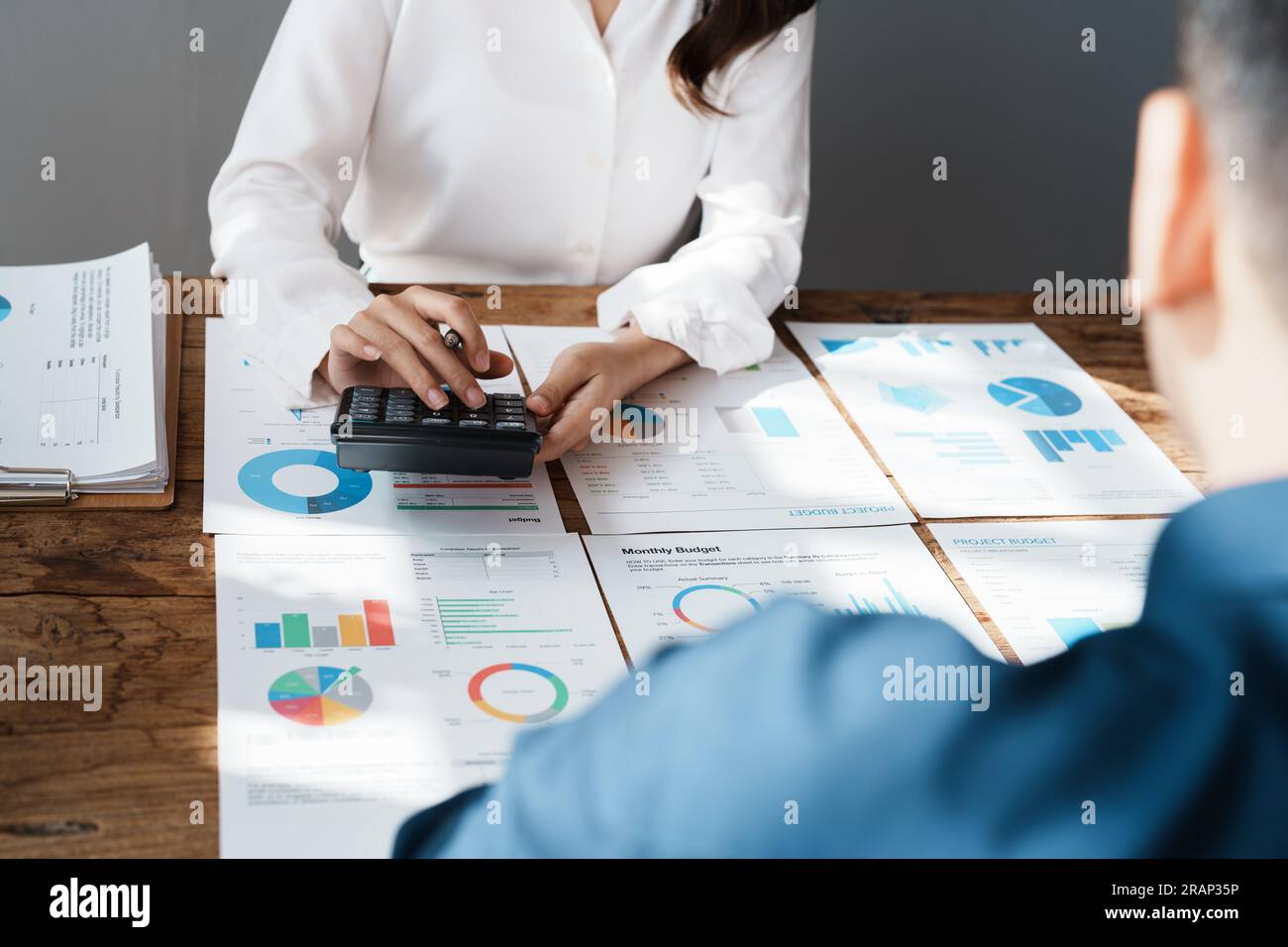 Accountant checking financial statement or counting by calculator ...