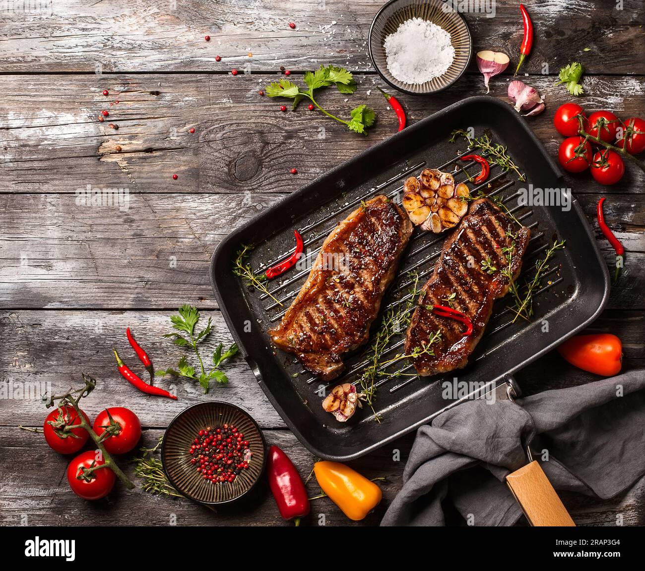 Grilled striploin steak with spices and herbs on grill iron pan.The ...