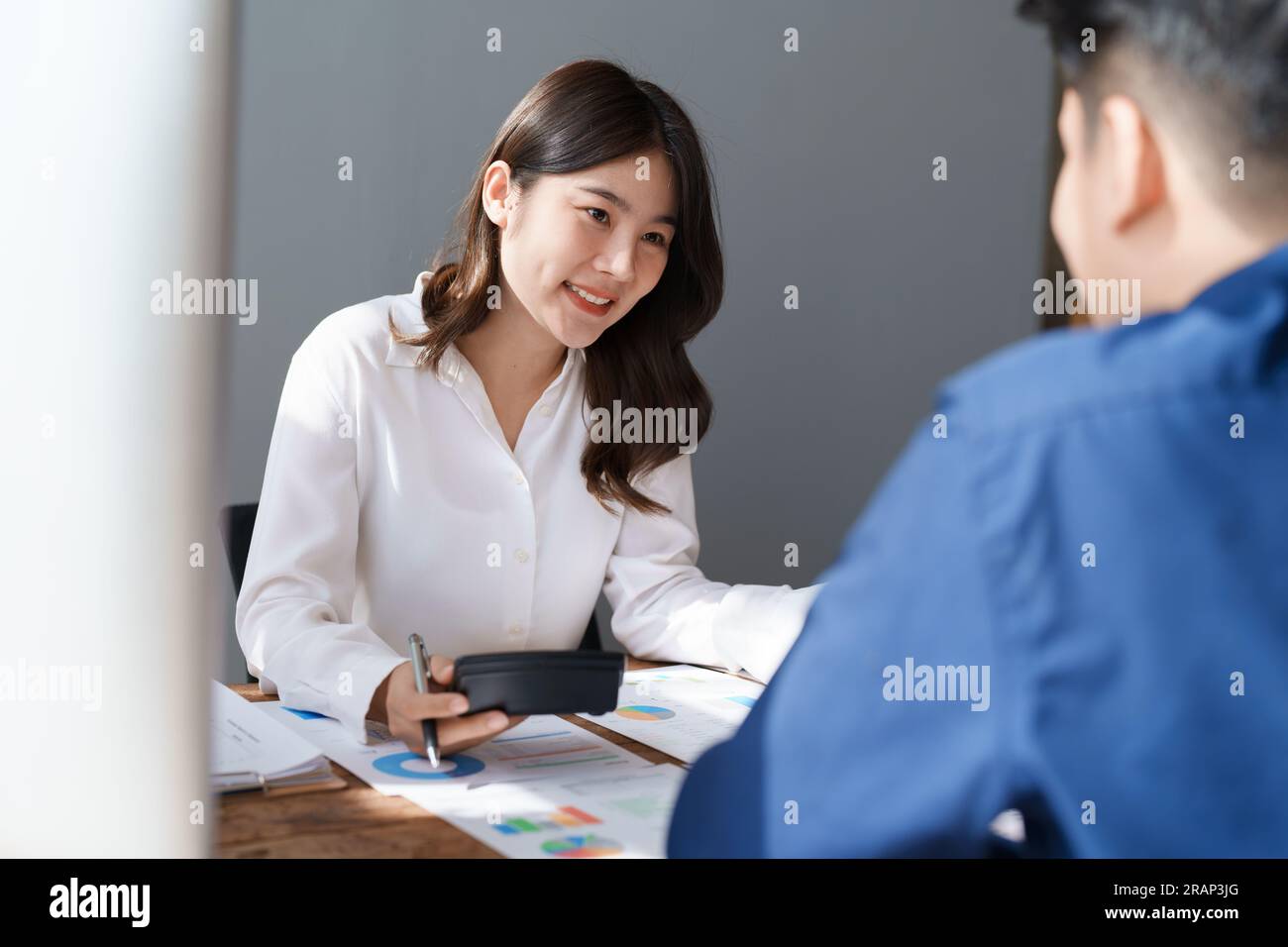 Accountant checking financial statement or counting by calculator ...