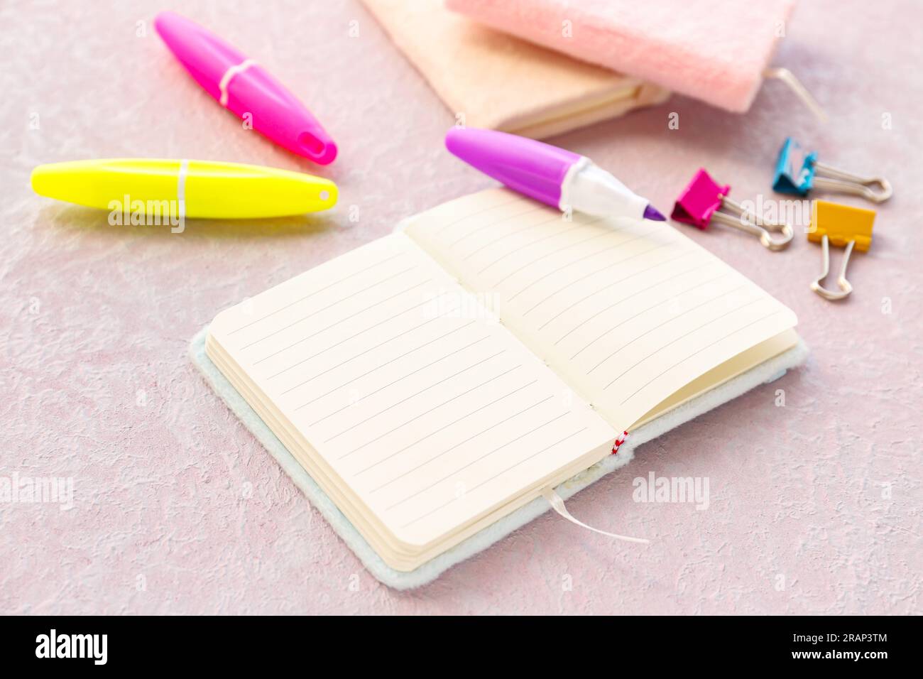 Blank open notebook, markers and binder clips on light background Stock ...