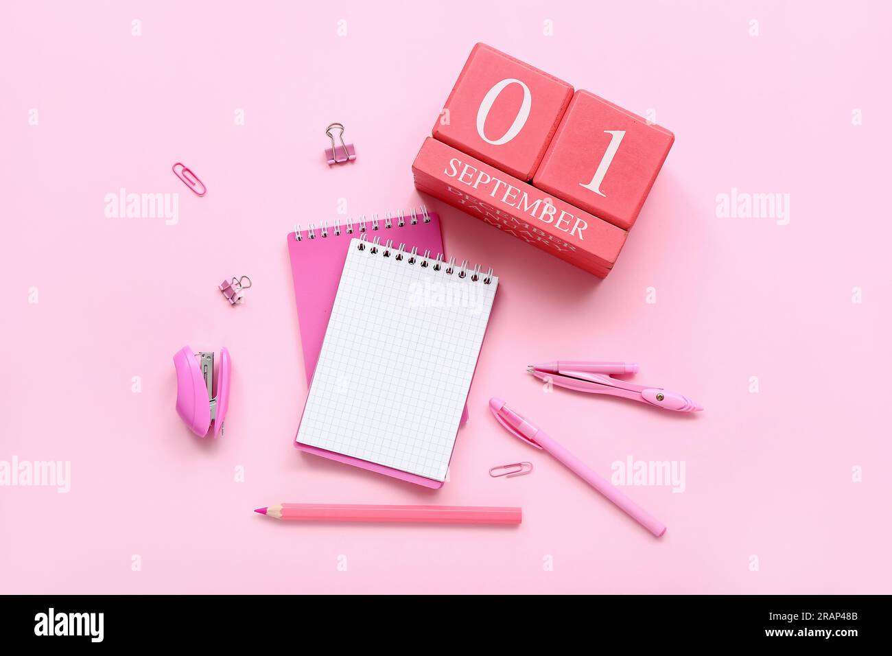 Blank notebook, stationery and calendar with date SEPTEMBER 1 on pink ...
