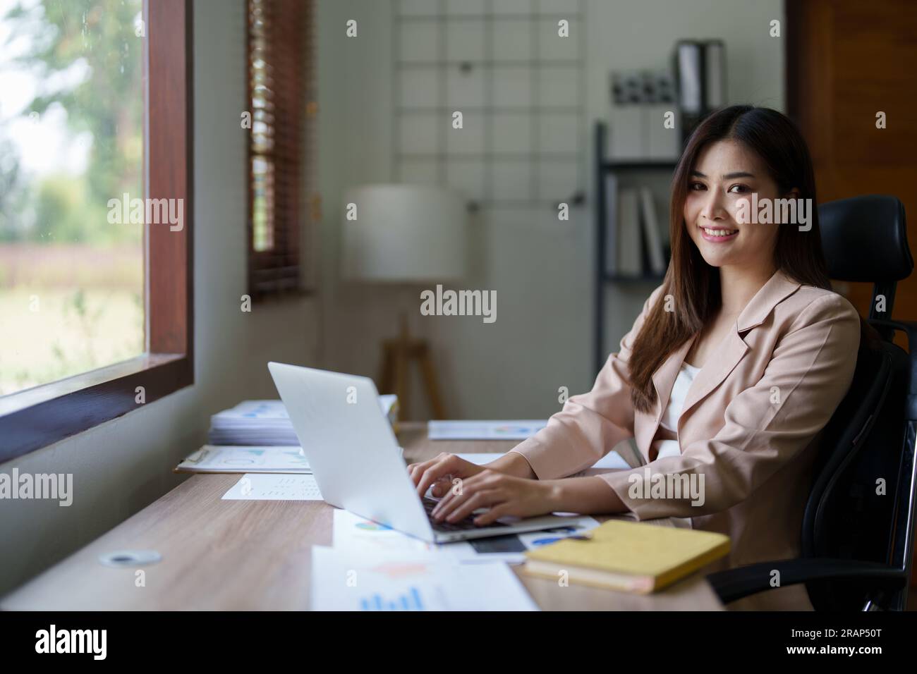 Young asian businesswoman manager, lawyer or company employee holding ...