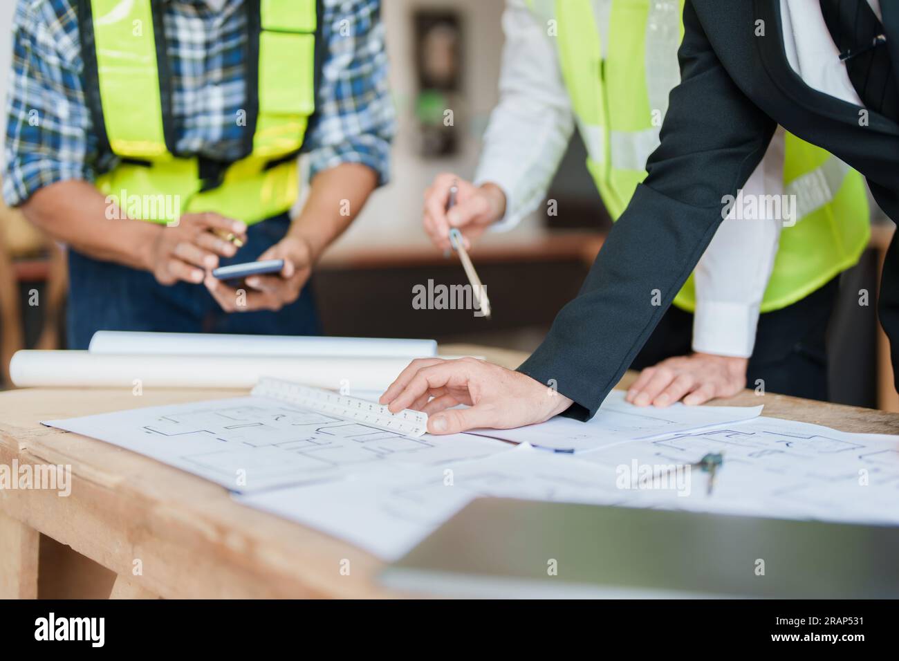 multi ethnic engineer brainstorming and measuring for cost estimating ...