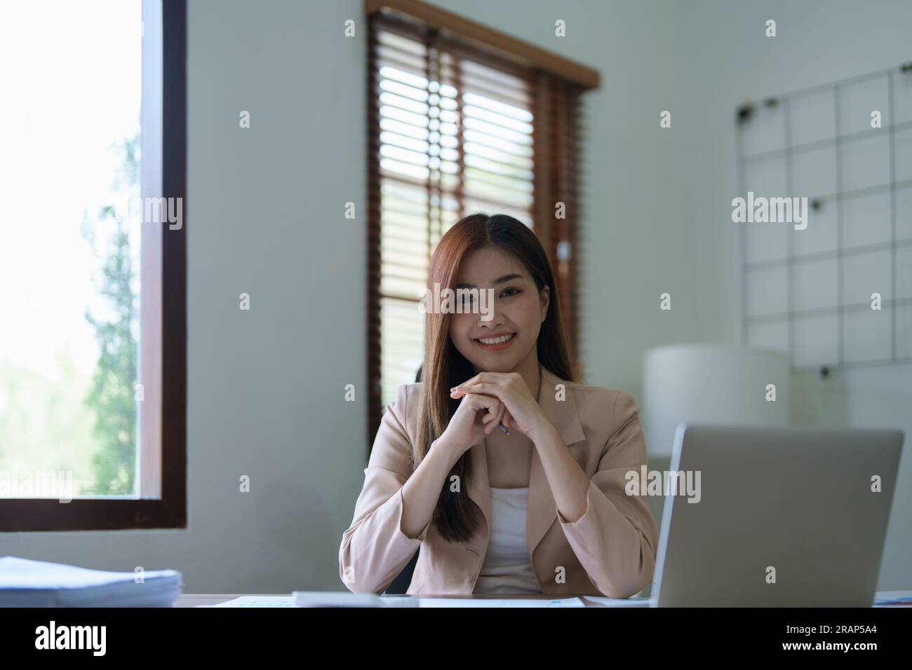 Portrait of a woman business owner showing a happy smiling face as he ...