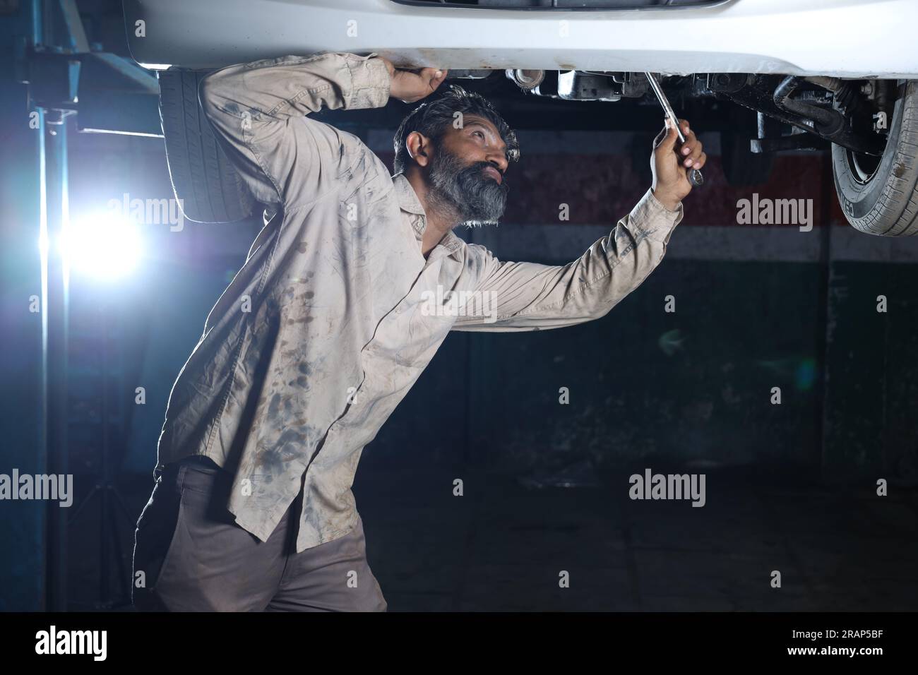 Mechanic working hard on car hi-res stock photography and images - Alamy