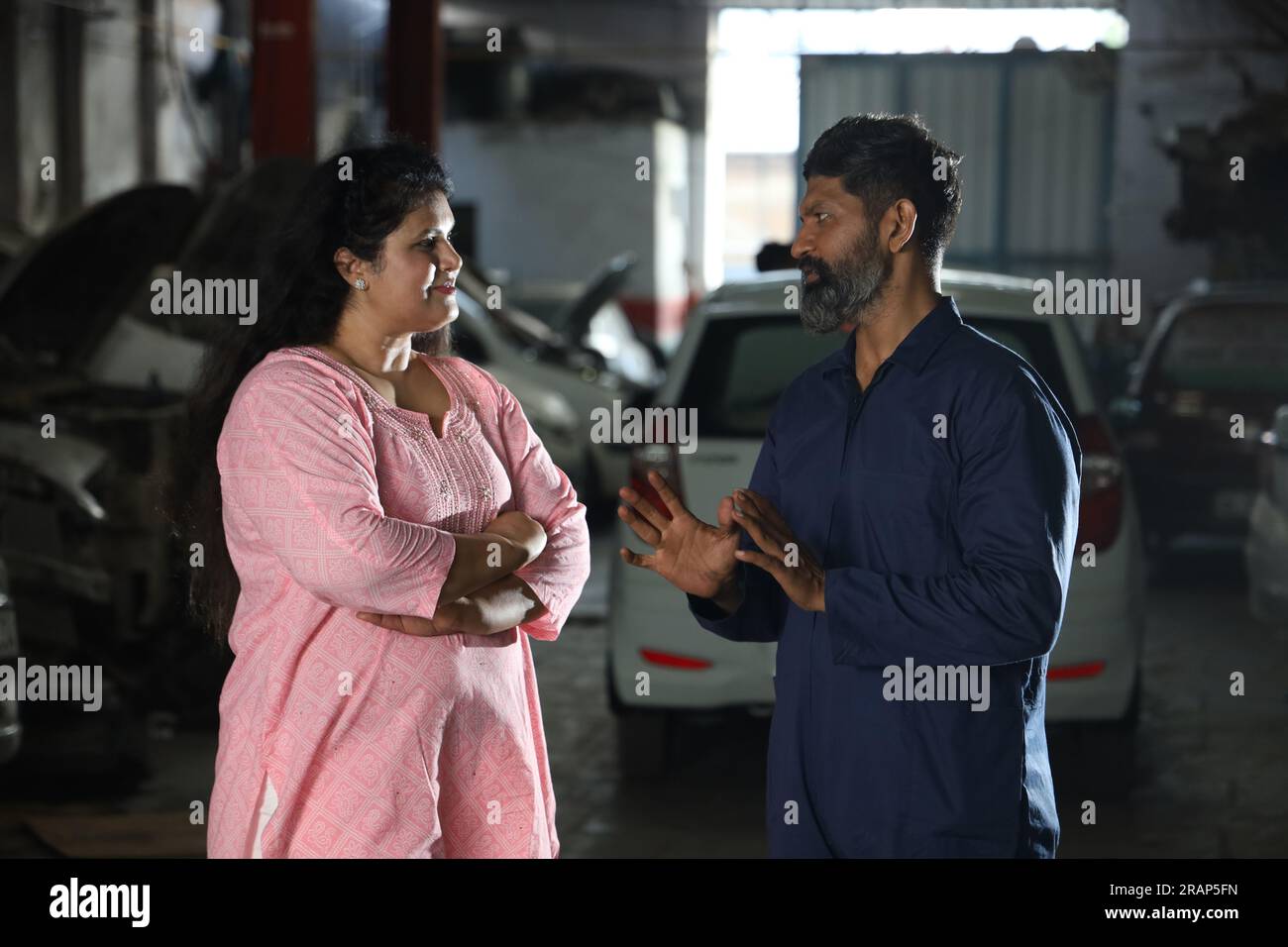 car mechanic standing with the happy customer shaking hands together ...