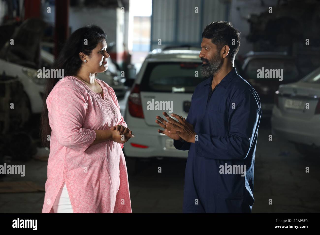 car mechanic standing with the happy customer shaking hands together ...