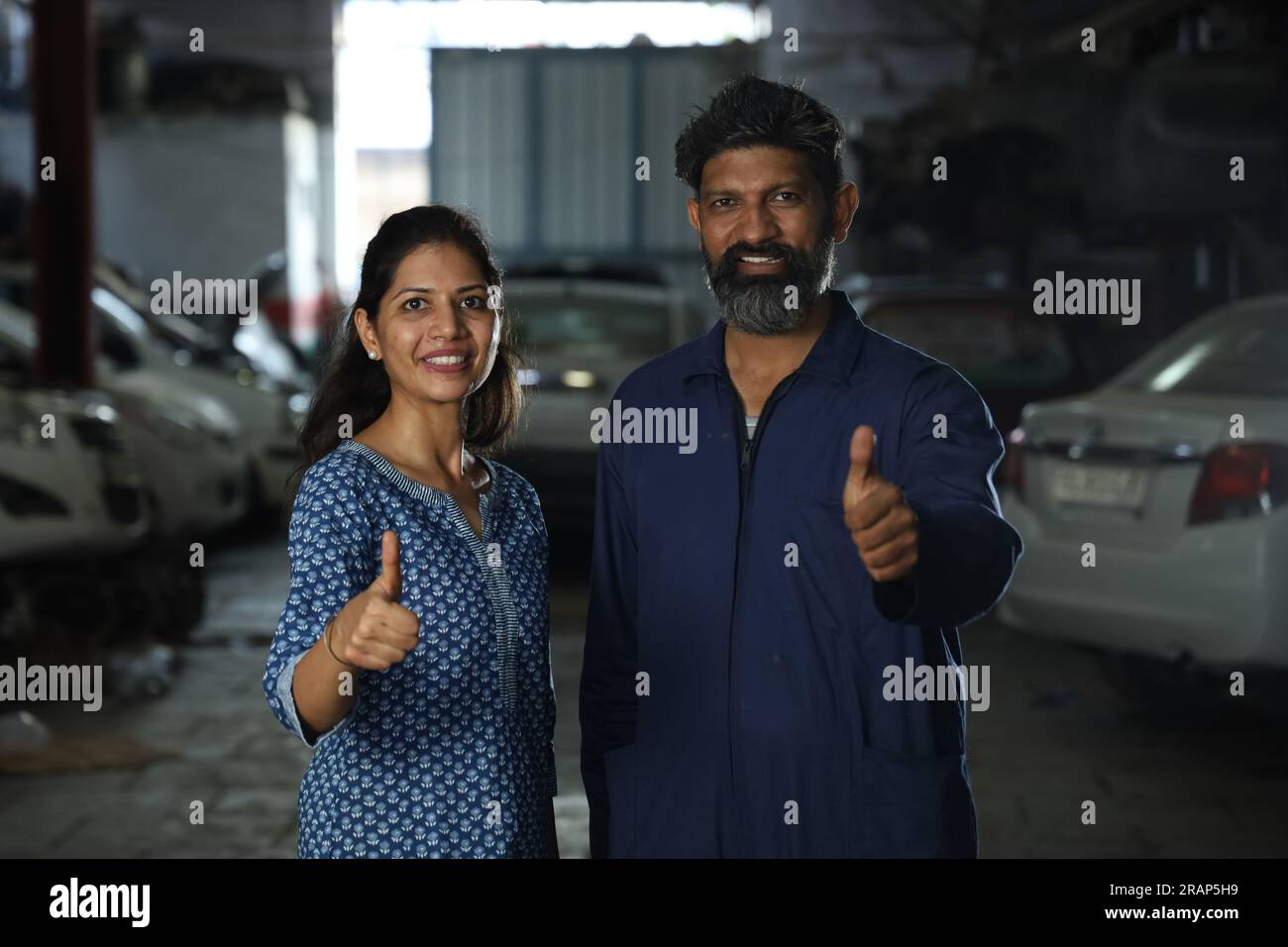 car mechanic standing with the happy customer shaking hands together ...